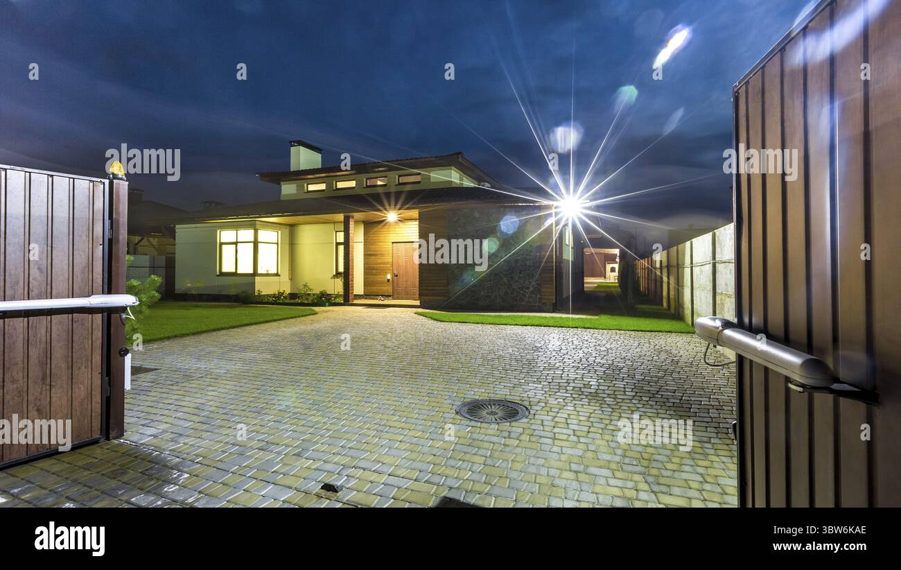 Detached luxury house at night - view from outside. Architecture modern ...