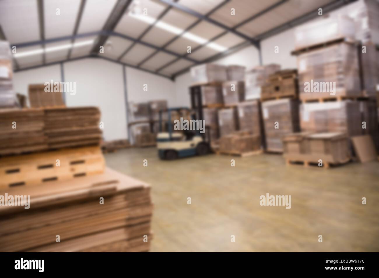 Fork lift by boxes in storage room Stock Photo - Alamy