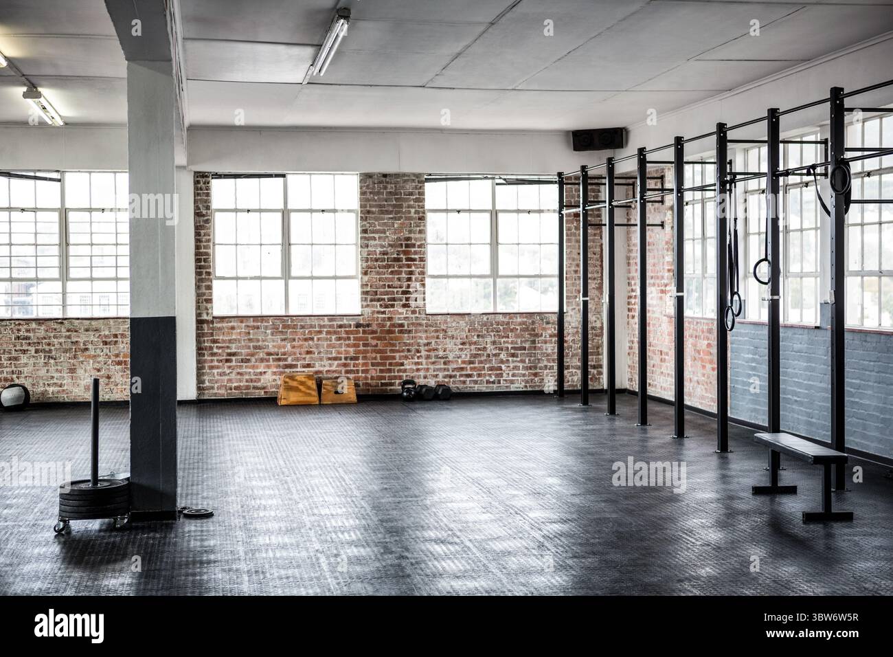 Flat design showing warehouse gym with weighted sled, boxes, dumbbells ...