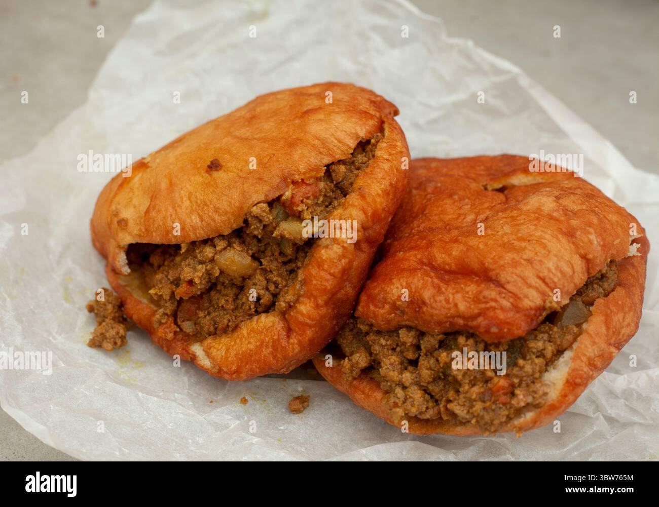 Traditional South African street food, vetkoek with curry mince Stock ...