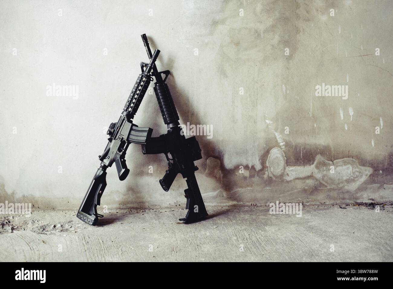 Rifle guns on grunge wall in abandoned house. Terrorist and Soldier concept. Robber and Police ...