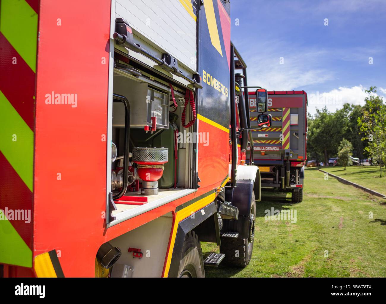 Modern fire truck parked on grass with open compartment showing ...