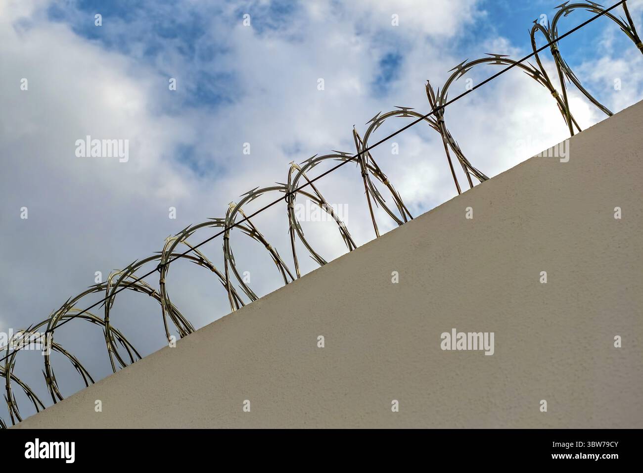 Concrete fence with barbed wire, Malaga, Spain Stock Photo - Alamy