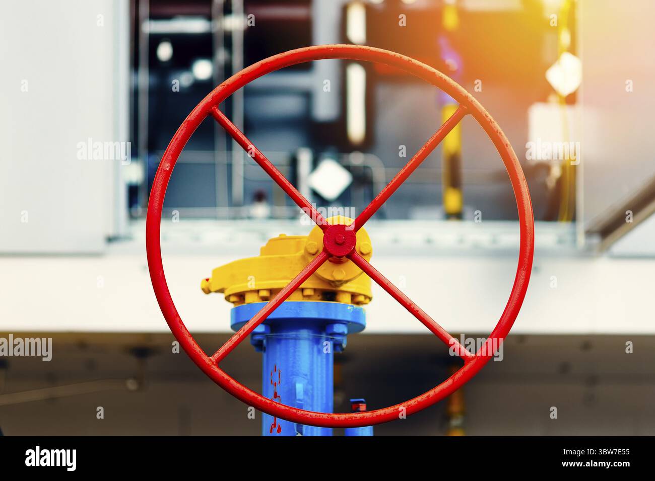 Round red valve close-up. Industrial background. Gasification or ...