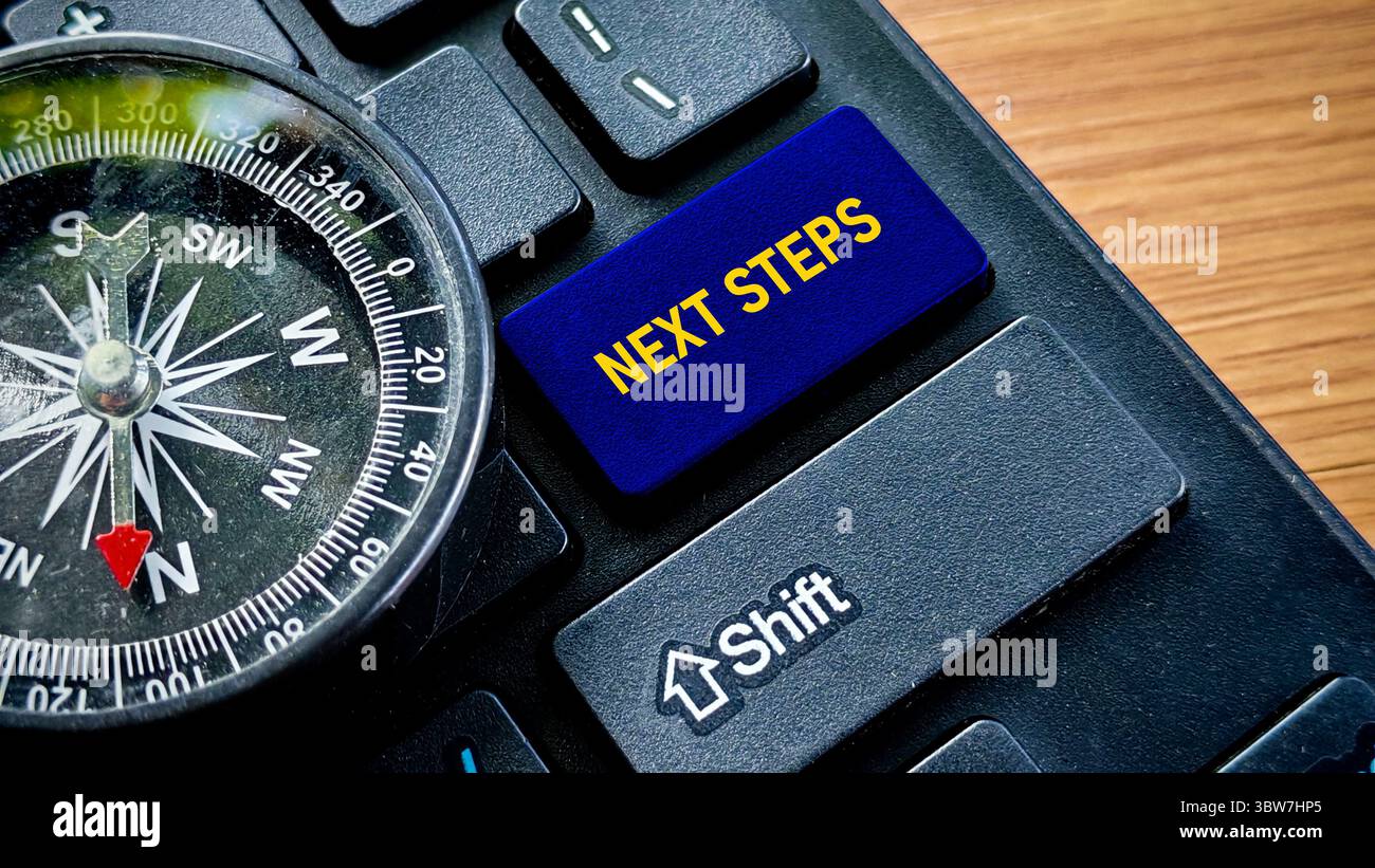 Next Steps Button on Keyboard with Compass Stock Photo - Alamy