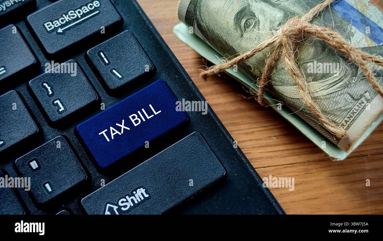 Tax Bill Button on Keyboard with Rolled Money Stock Photo - Alamy