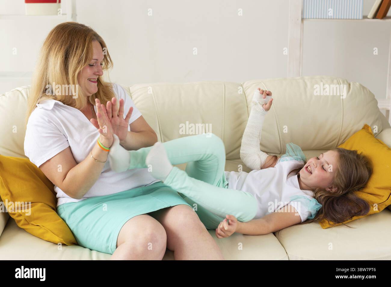 Mother spend time with your child girl with a cast on a broken wrist or ...