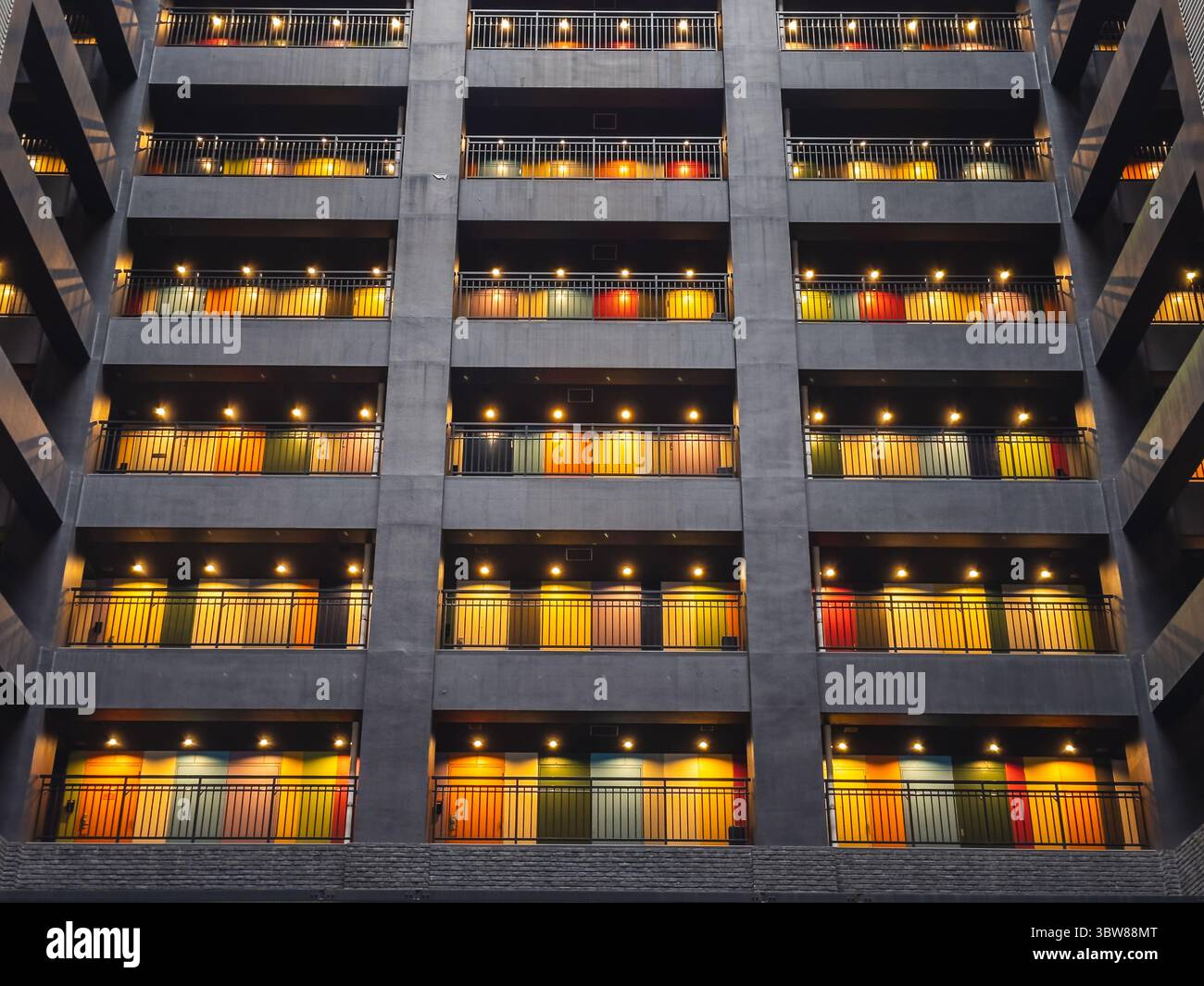 Vibrant apartment building interior at night. Colorful doors and ...