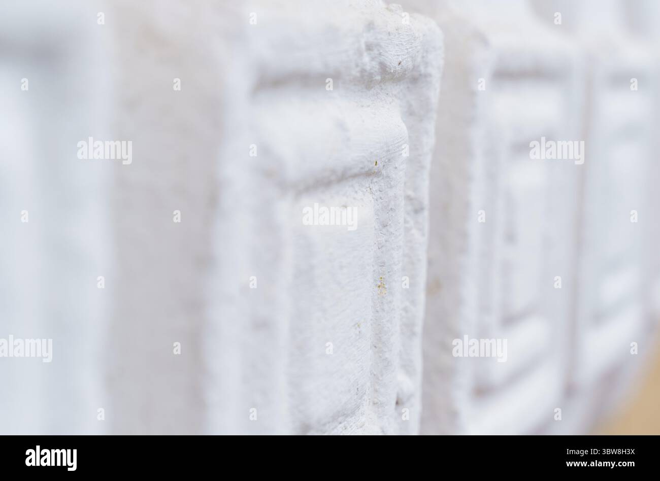Close-up view of a textured white wall featuring distinct shapes and ...
