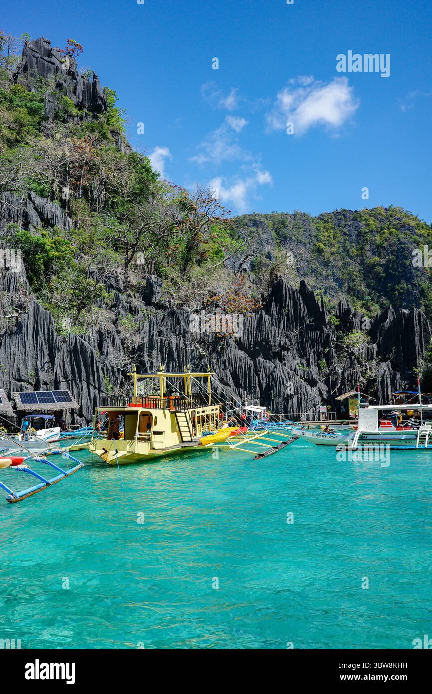 A unique design of a Filipino long-tail boat, unique limestone cliffs ...