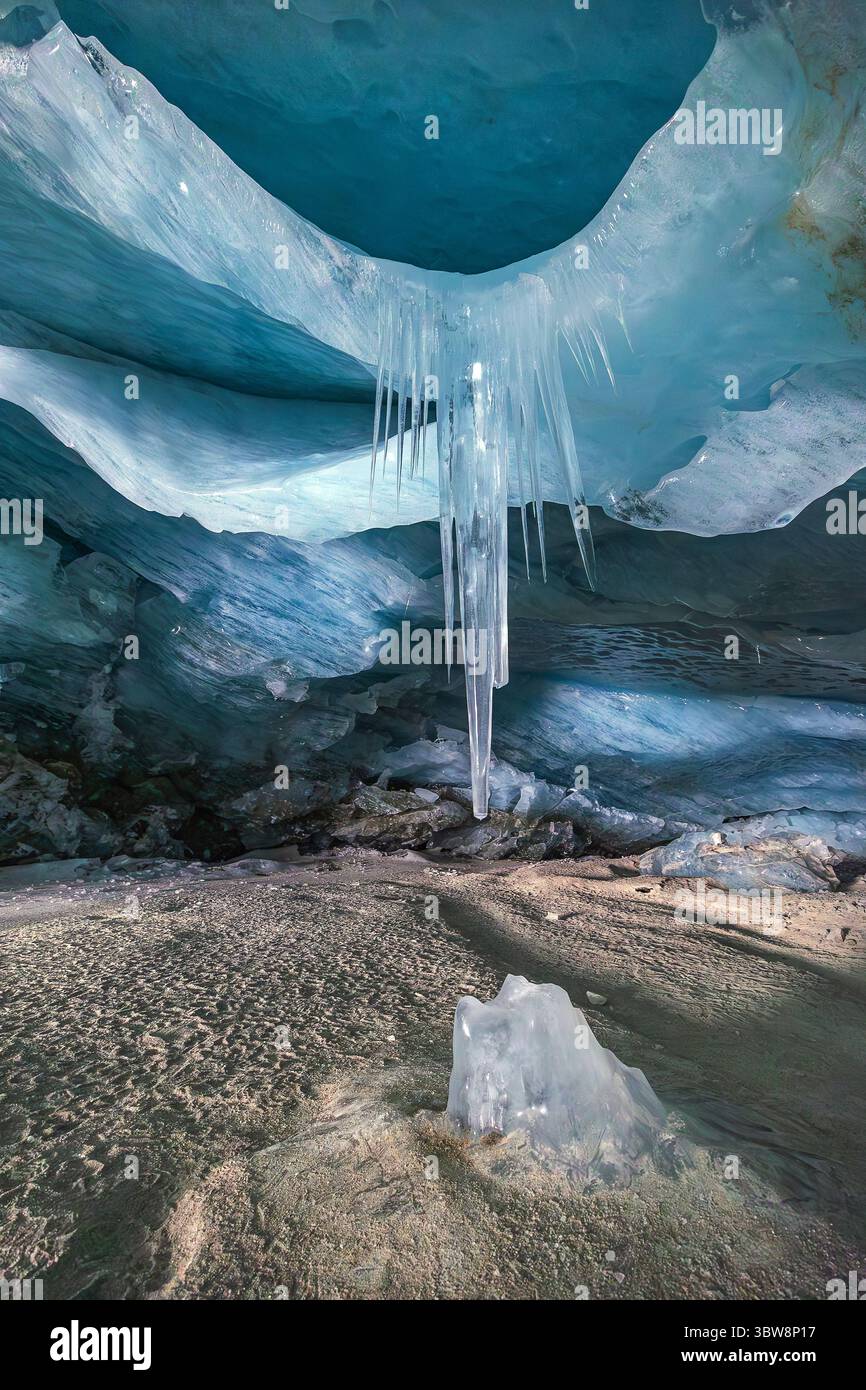 Huge icicle hanging from an ice cave ceiling in the Morteratsch glacier ...