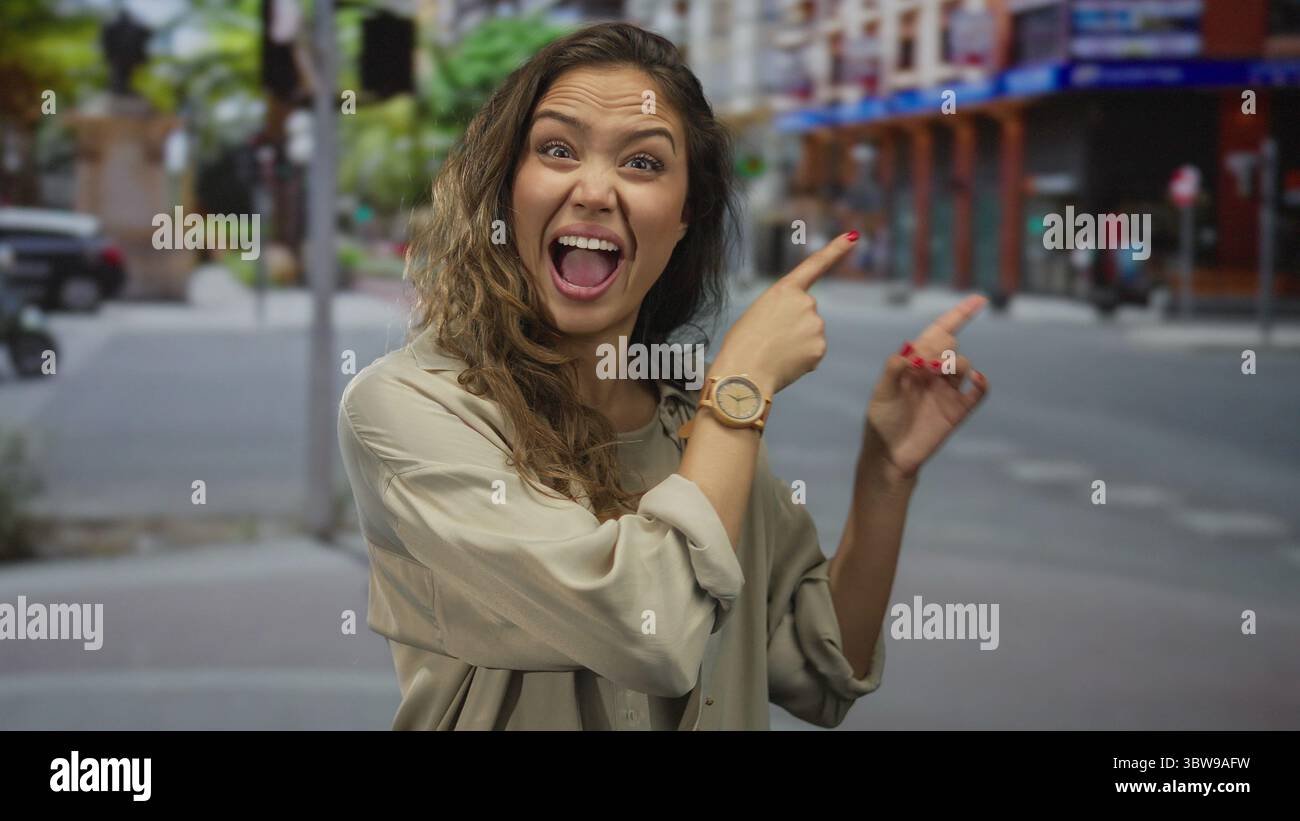 Woman pointing enthusiastically in vibrant urban street setting ...