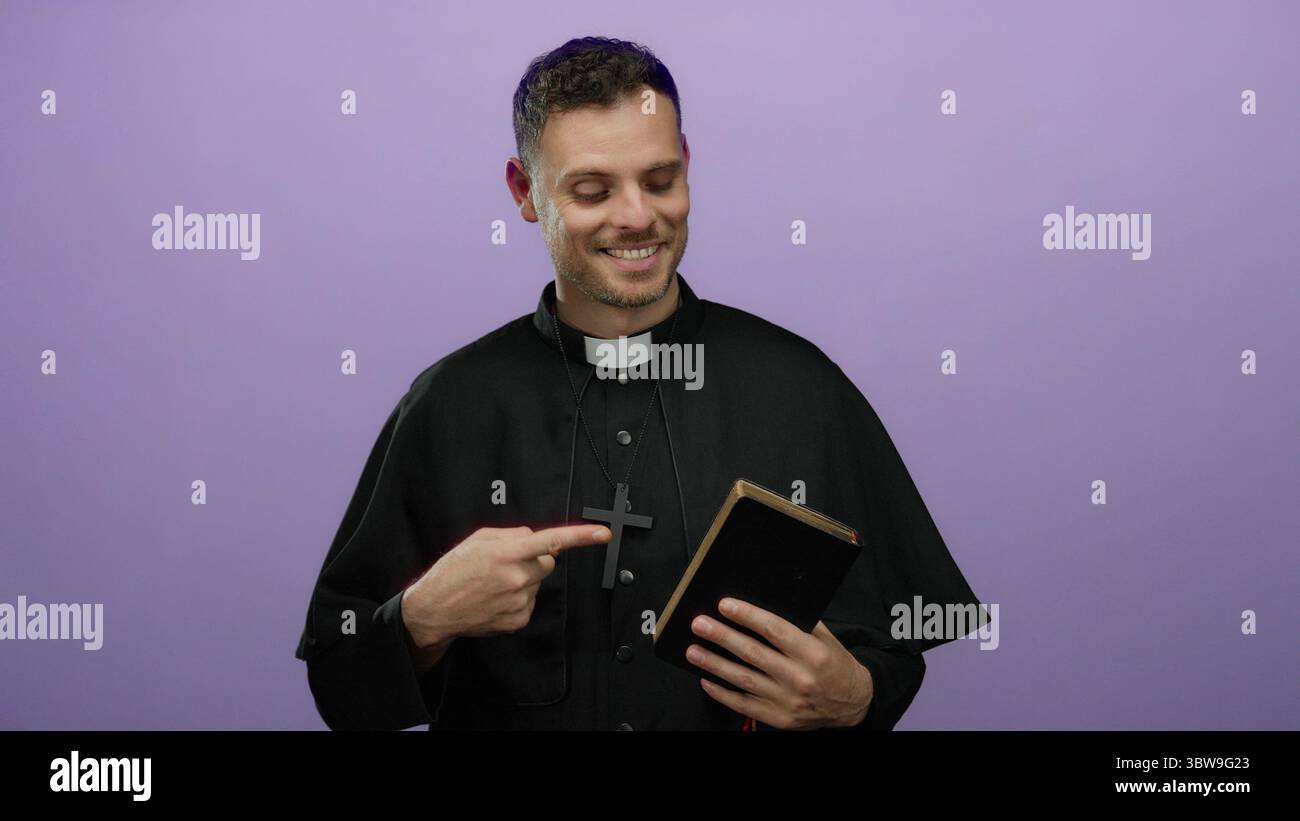 Hispanic man priest pointing at a bible, wearing black clerical attire ...