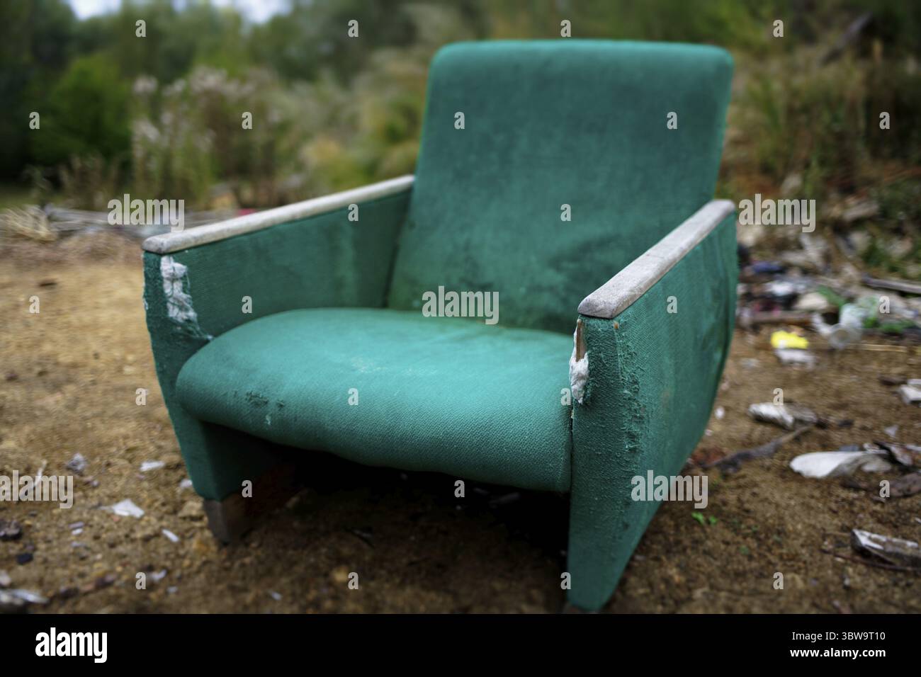The old chair is in a landfill. Abandoned wasteland with waste and ...