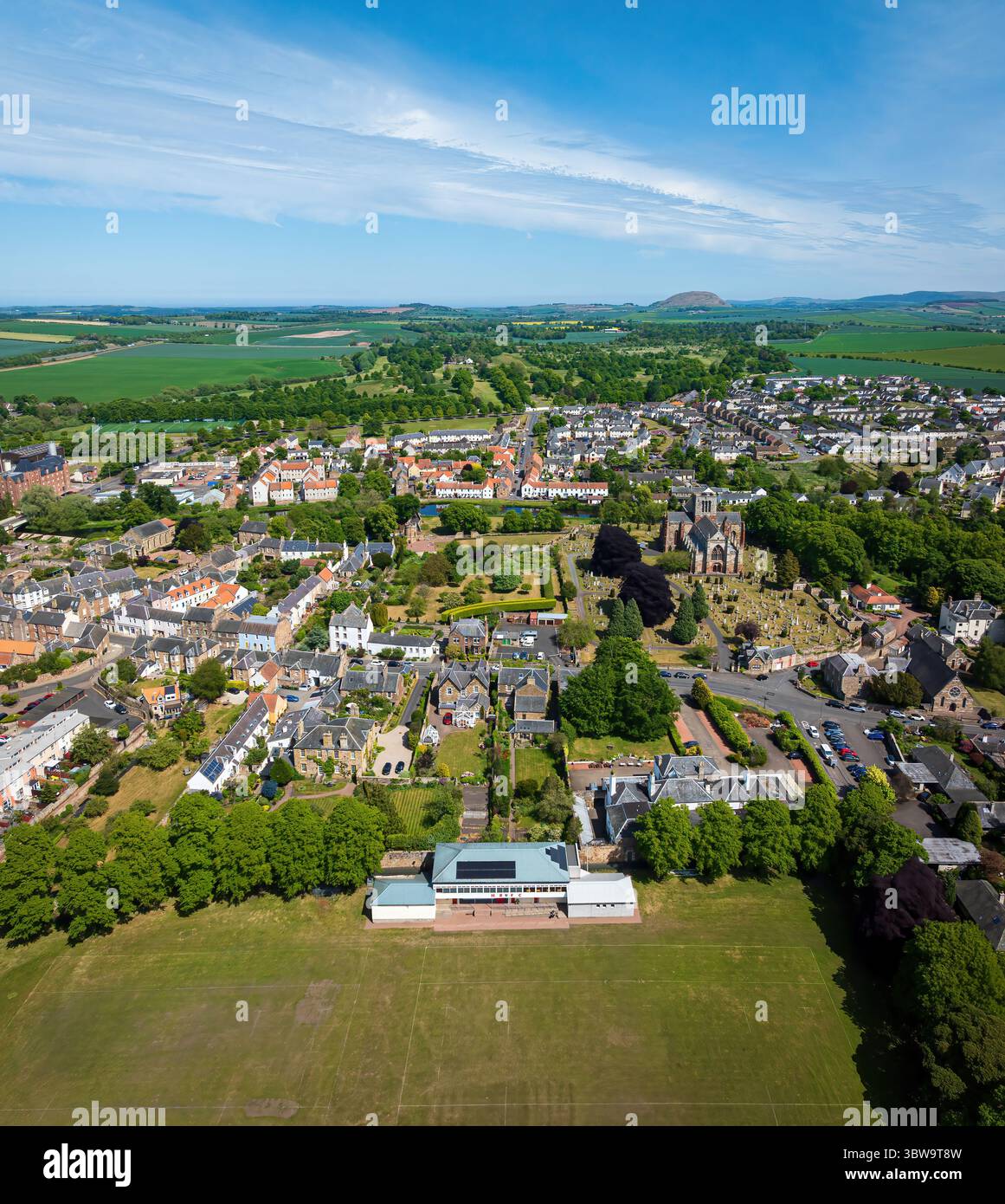 Aerial view of the charming town nestled amidst verdant fields, with ...