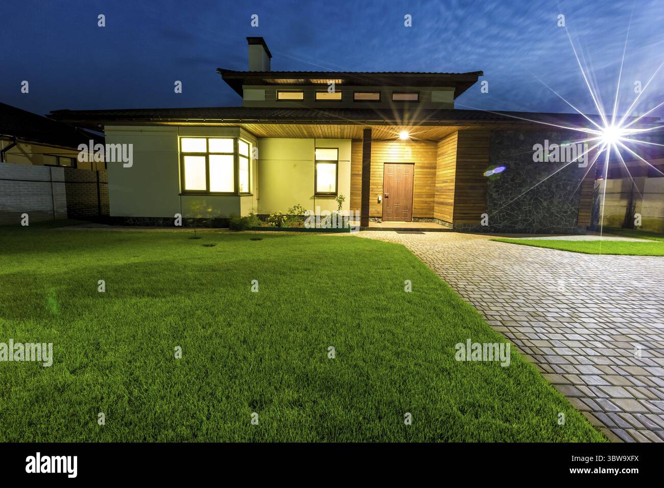 Detached luxury house at night - view from outside front entrance ...