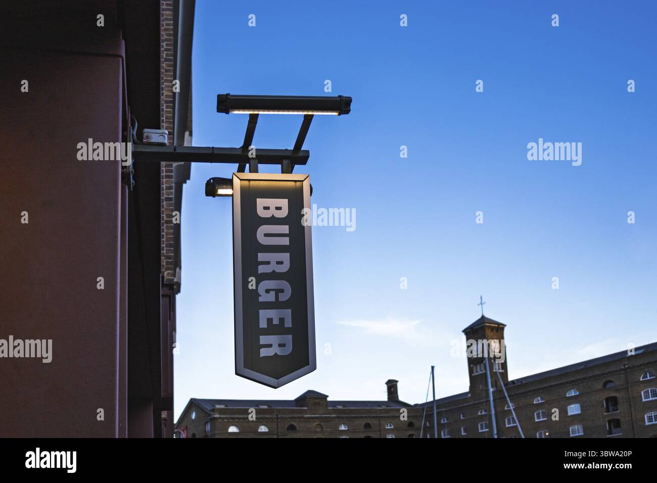 Urban burger bar signage with bold typography seen in warm evening ...