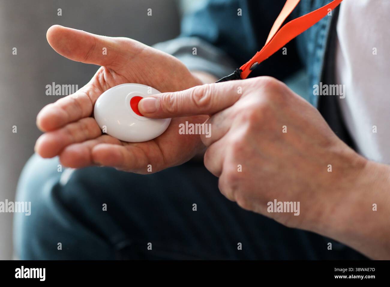 Man pushing panic button on emergency equipment for elderly people ...