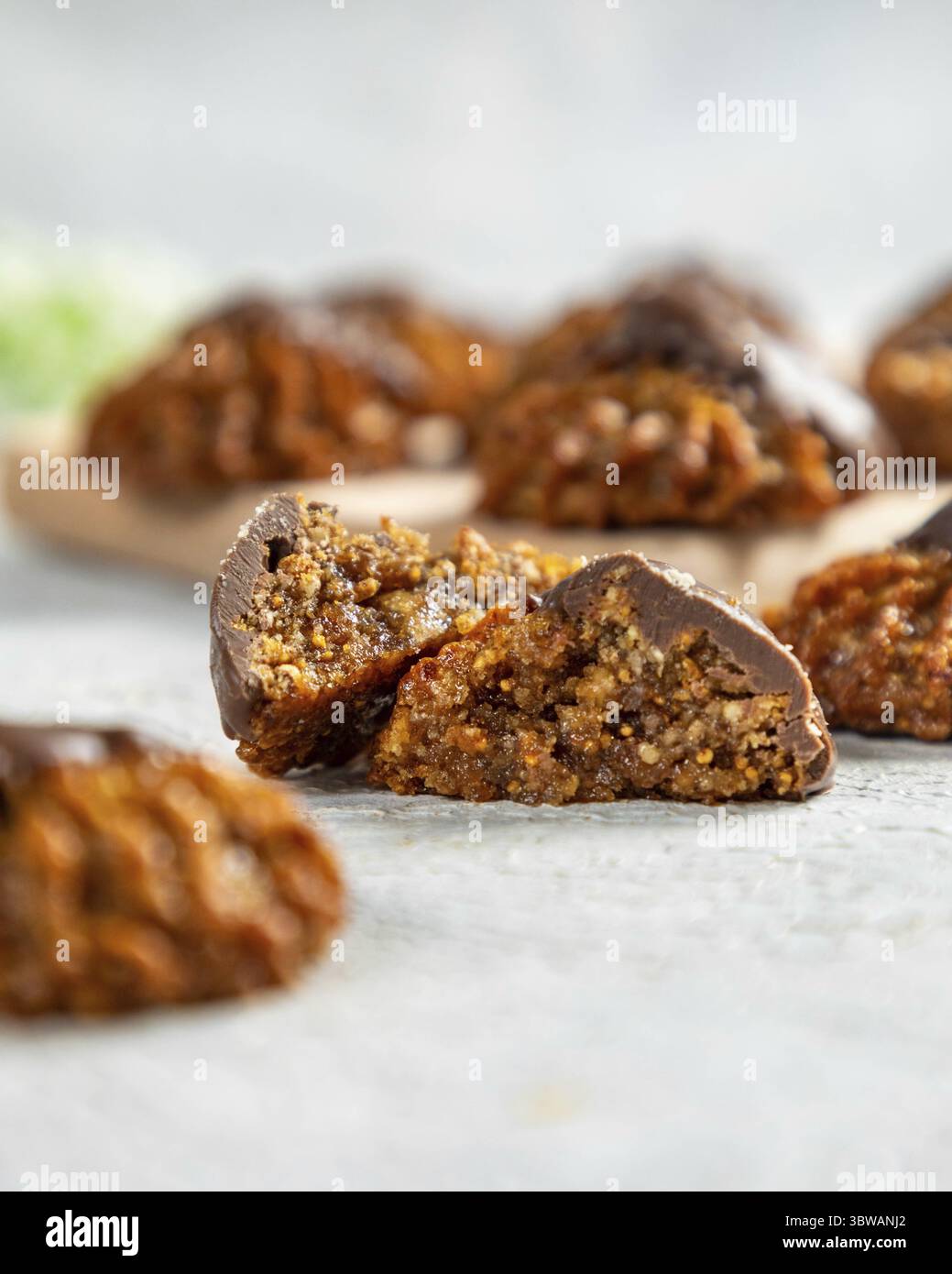 Delicious homemade fig and nut cookies covered in chocolate are broken ...