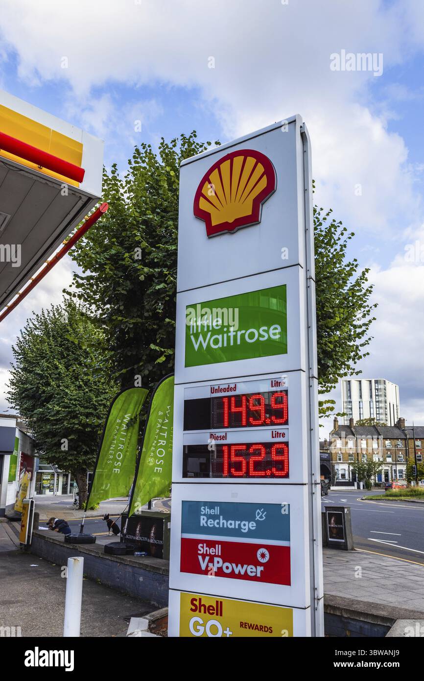 Shell gas station signage with fuel prices, bright branding, and urban ...