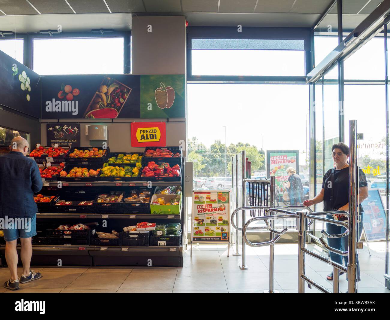 Cremona, Italy July 12nd 2025 A customer choosing fresh vegetables at ...