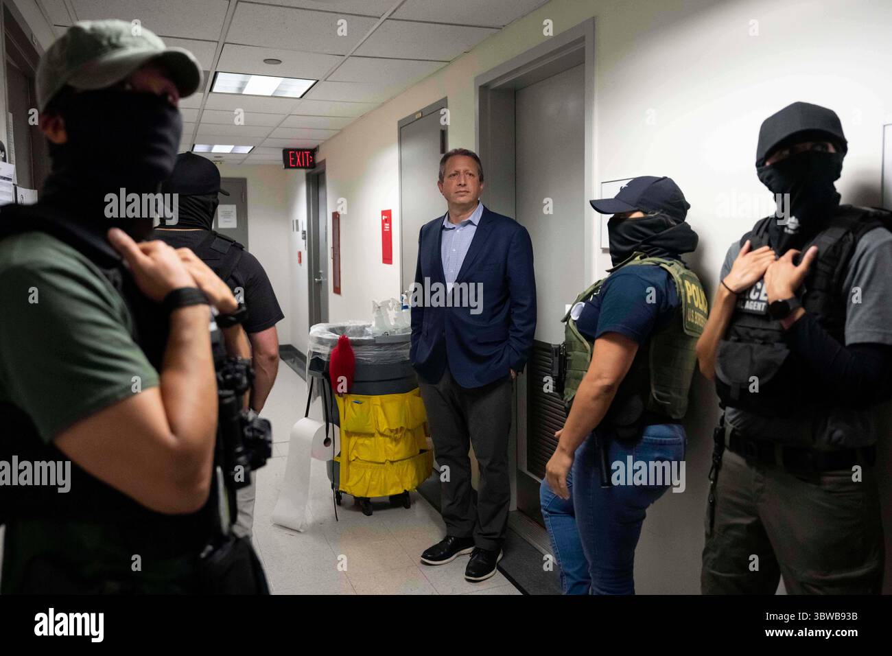 New York City Comptroller Brad Lander stands near federal agents ...