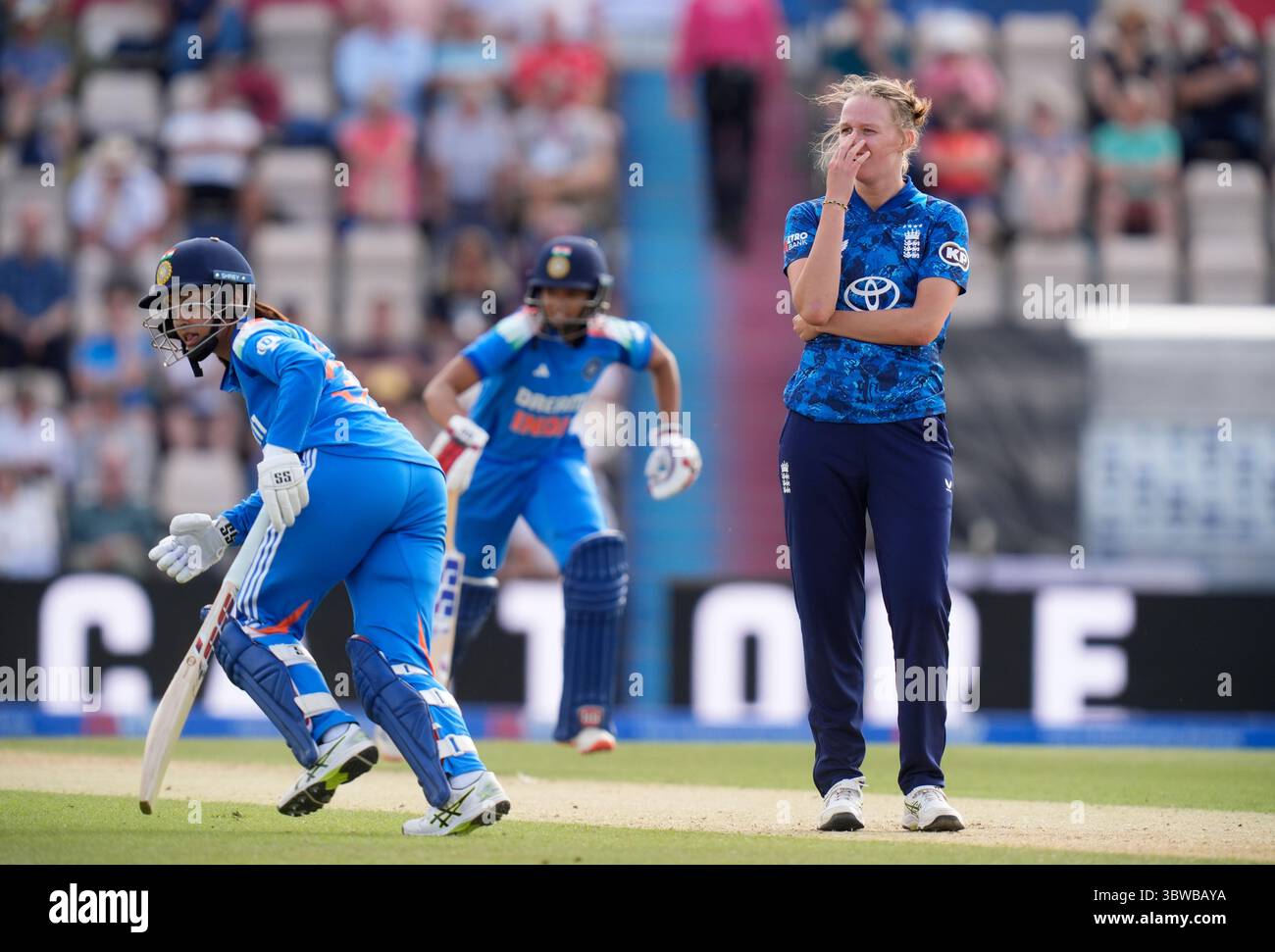 England's Lauren Filer (right) reacts as India's Harleen Deol (left ...
