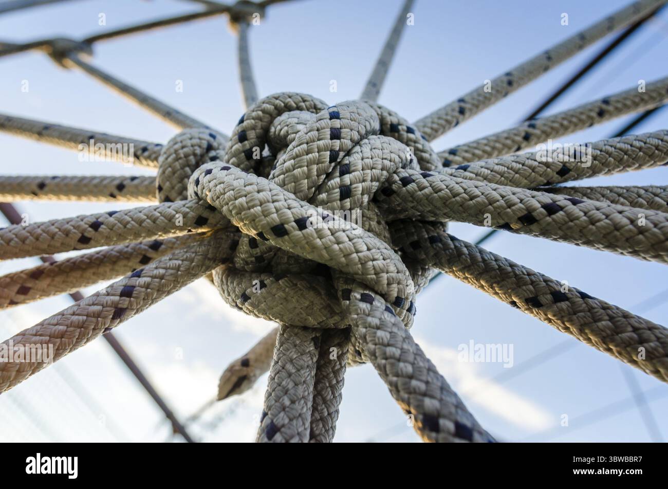 Many ropes and one big knot close up Stock Photo - Alamy