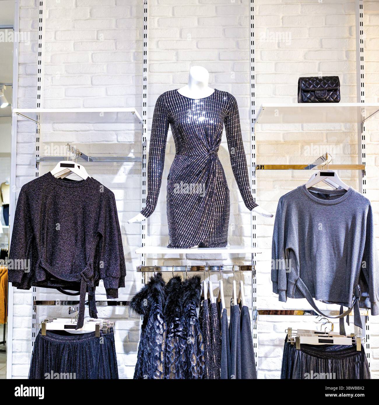 An empty woman fashion store with mannequin displaying the latest trend ...