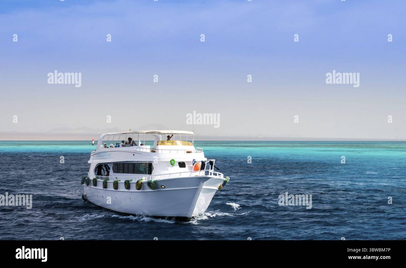 Large white pleasure boat in the blue water of the Red Sea Sharm El ...