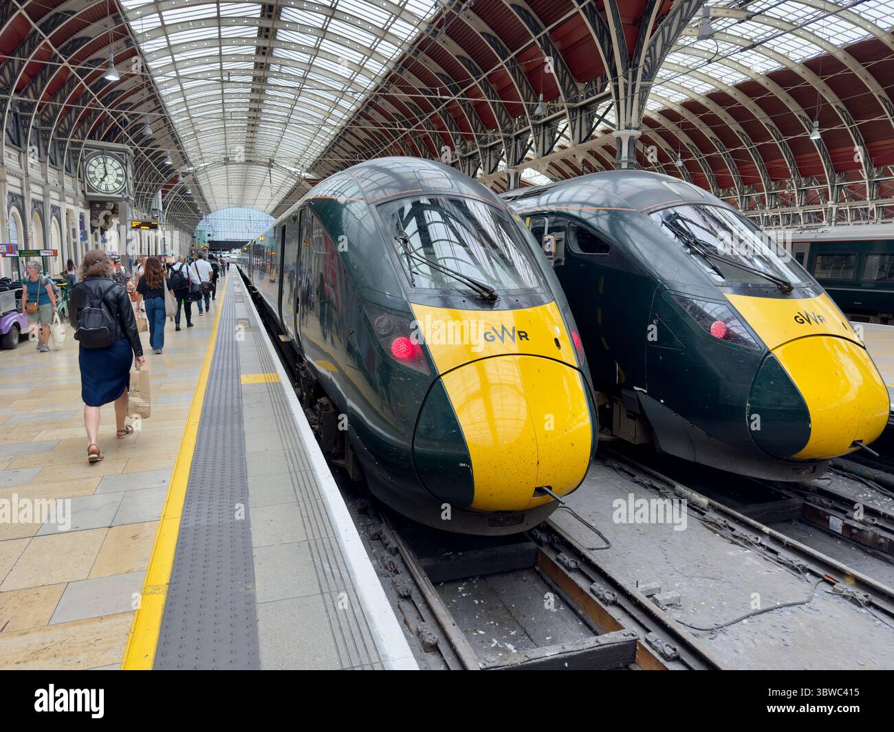 July 2025 Two GWR trains side-by-side at London Paddington Station in the early evening as ...