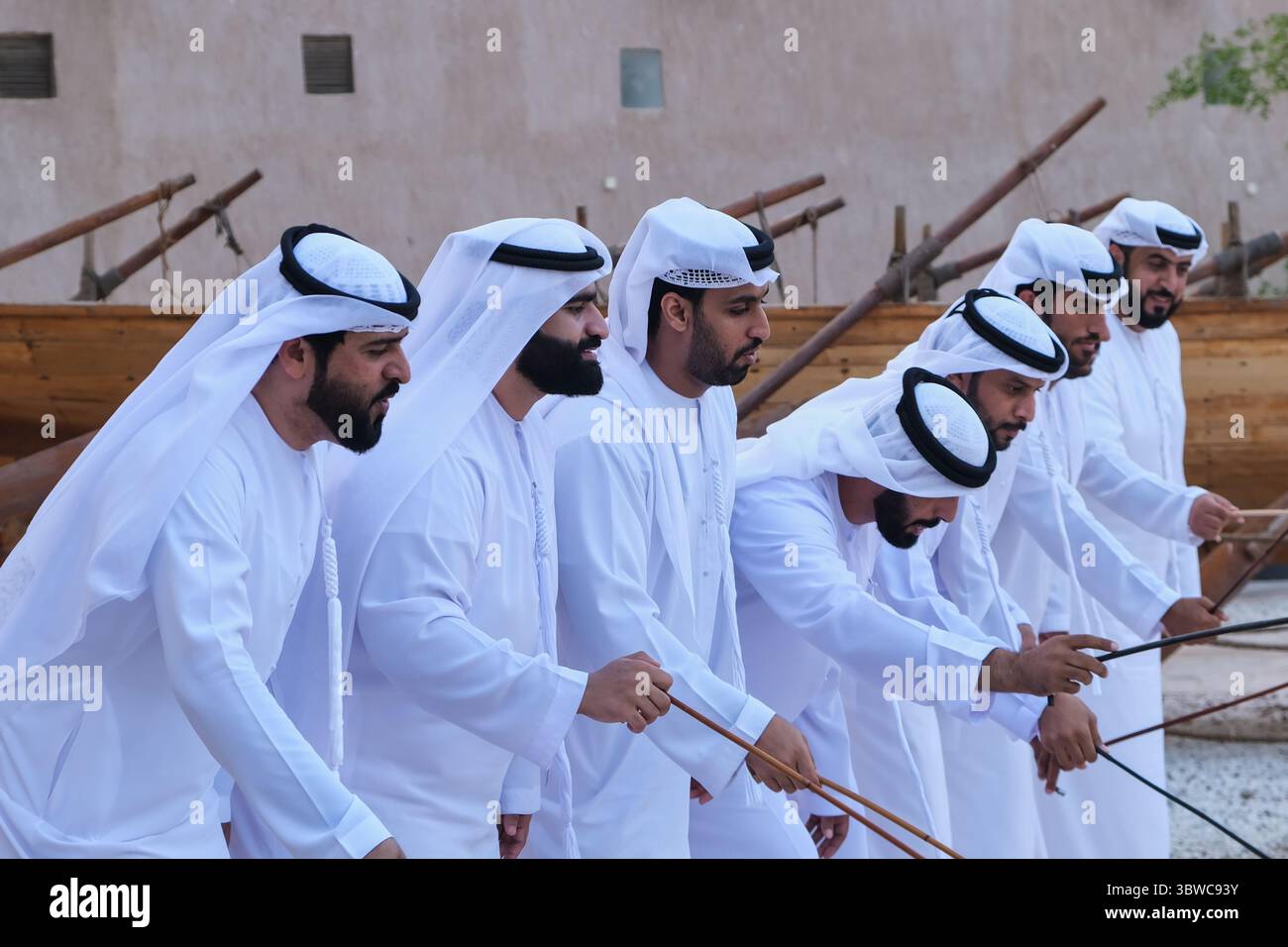 Group of Emirati men in traditional attire,white thobe and ghutra ...