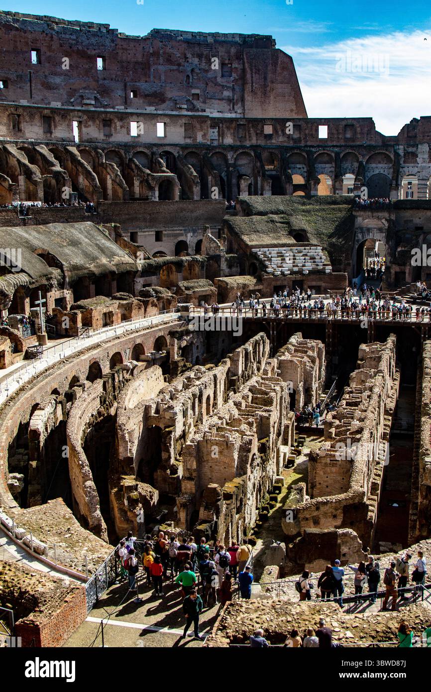 A crowd of people visiting the interior of the great Roman Colosseum ...