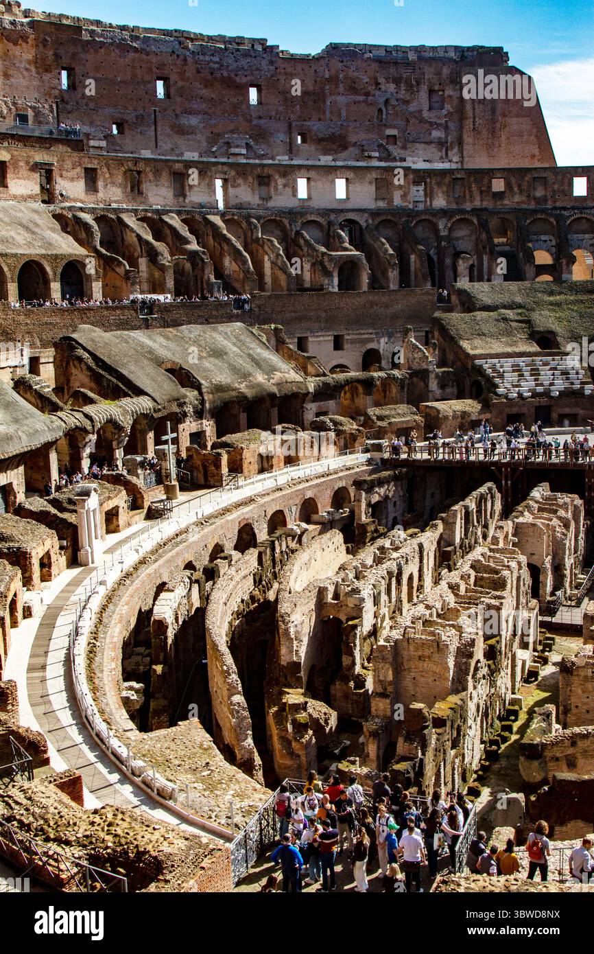 A crowd of people visiting the interior of the great Roman Colosseum ...