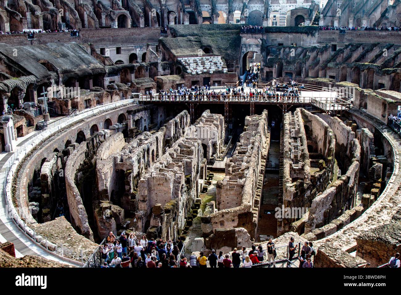 A crowd of people visiting the interior of the great Roman Colosseum ...
