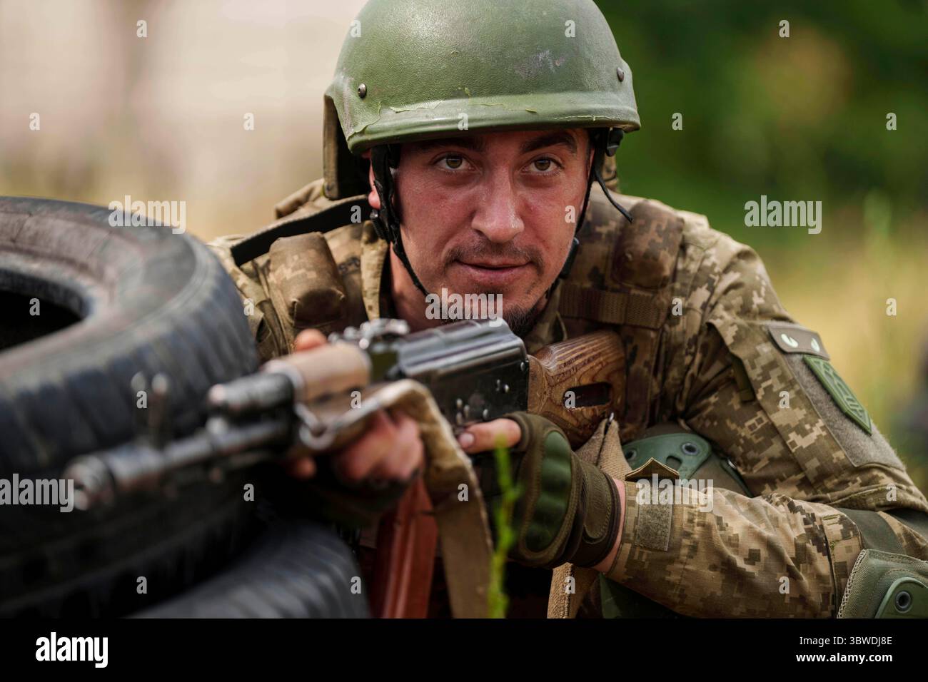 A Ukrainian 3rd Assault Brigade recruit trains at the polygon in Kyiv ...