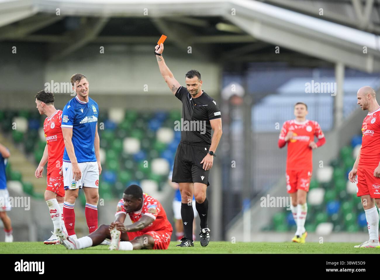 Linfield's Ben Hall is shown a red card during the UEFA Champions ...