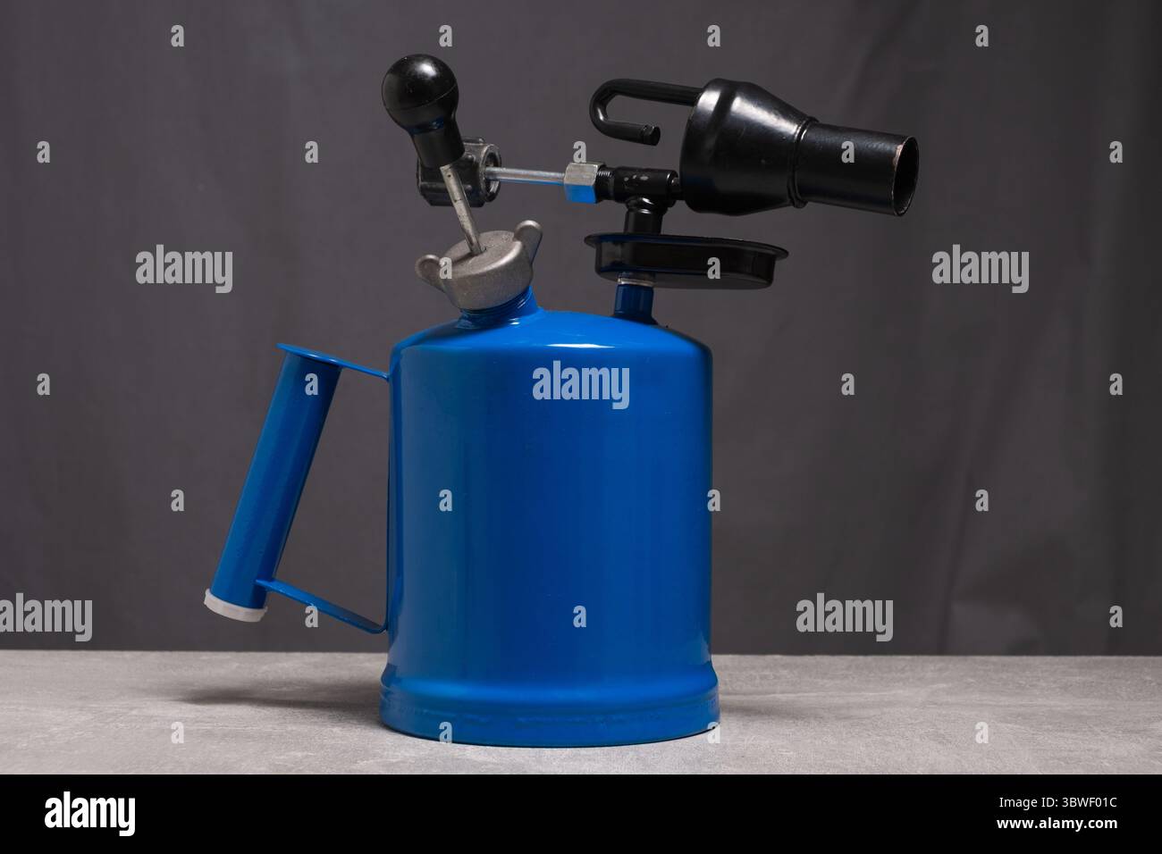 Blue blowtorch on gray background Stock Photo - Alamy