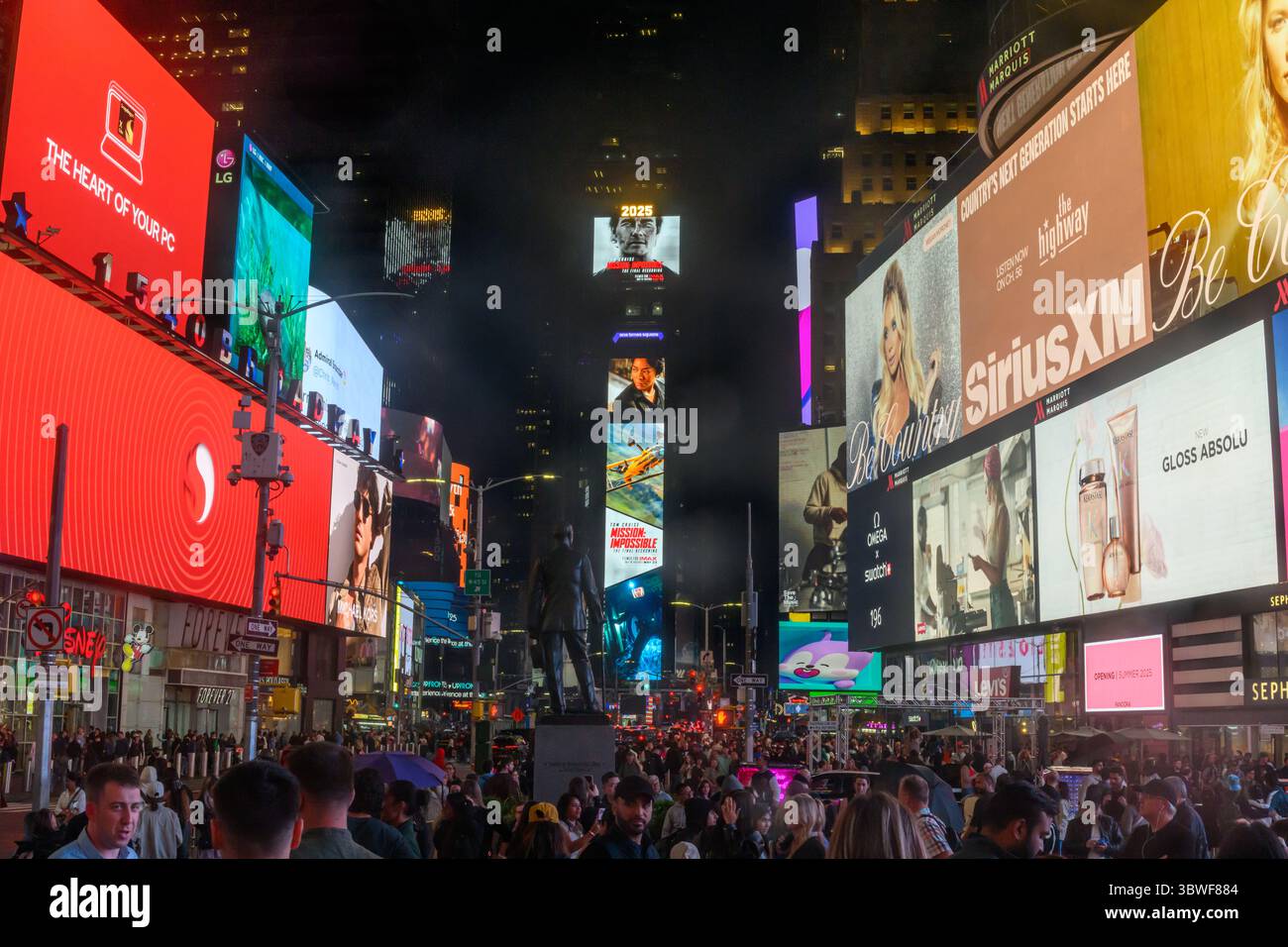 A Typical Nightime Scene Of The Lights And People Of Times Square New ...