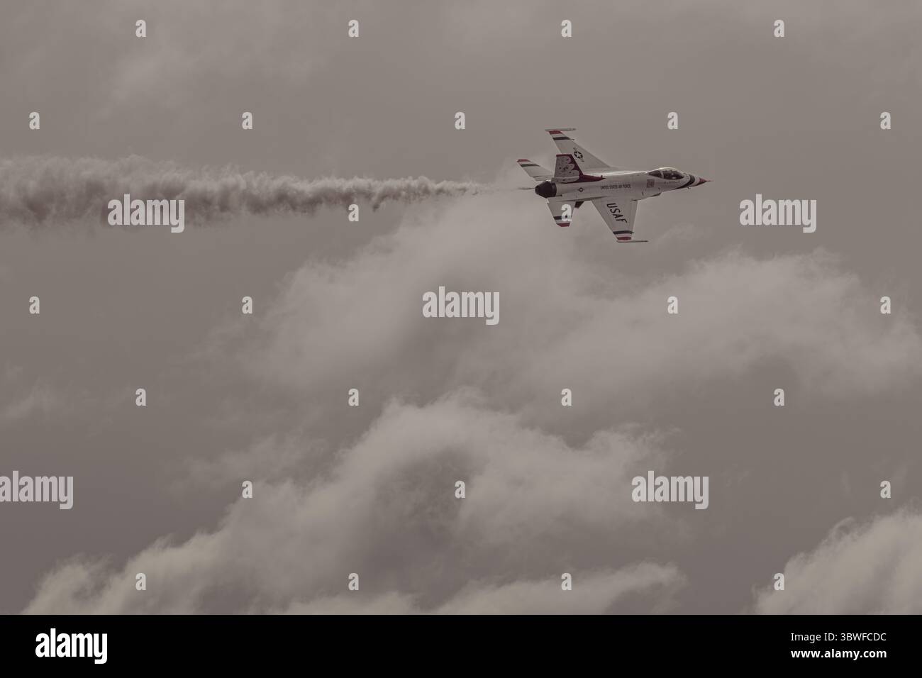 USAF Thunderbird No. 3 performs a solo pass trailing smoke during the ...