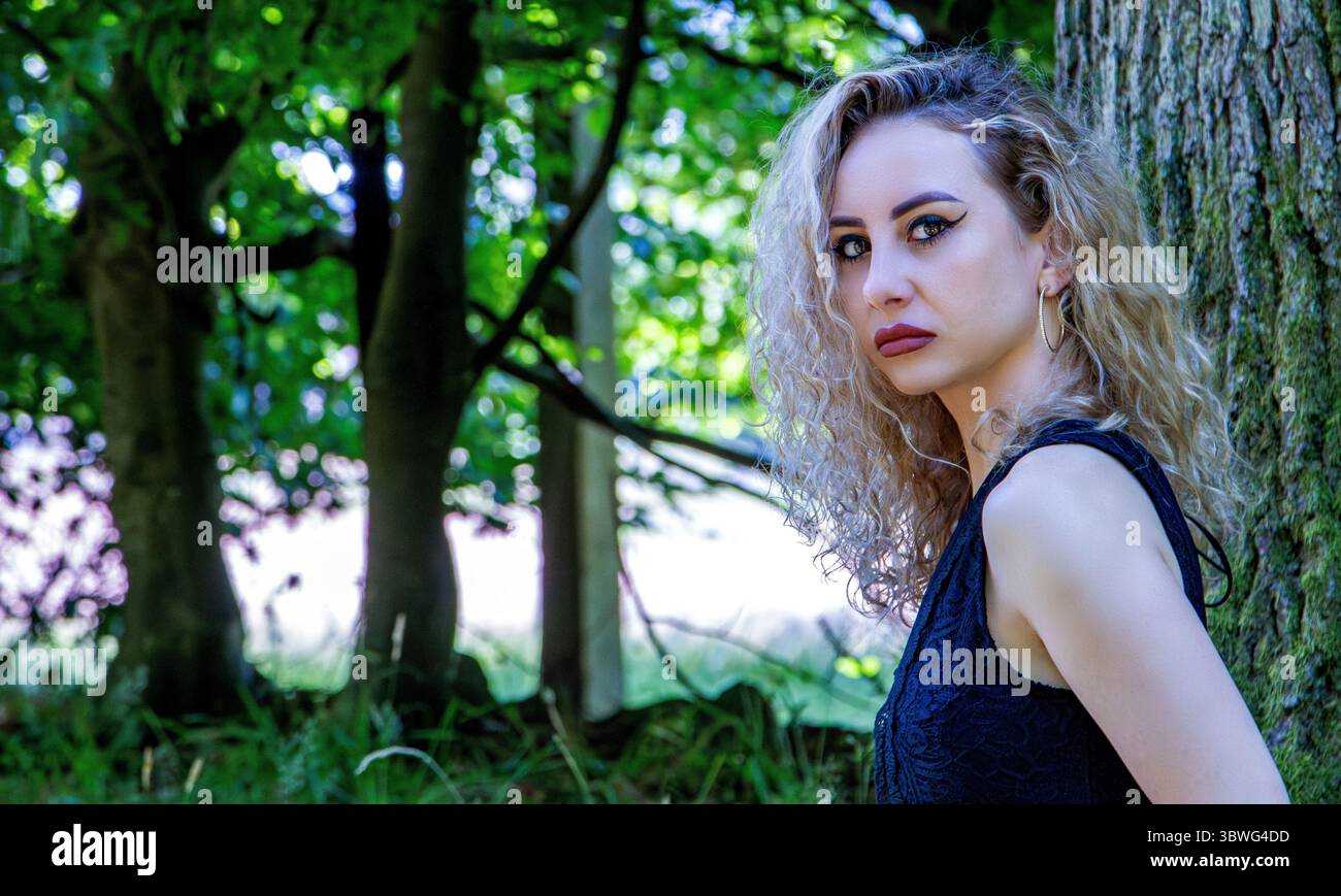 A beautiful blonde Moldovan model poses on a sunny July day under ...