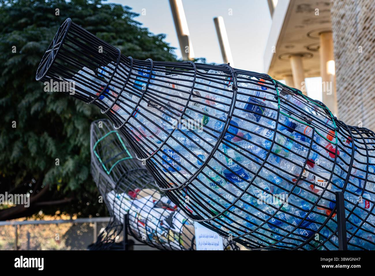 Bottle-shaped recycling bin filled with plastic waste at Children's ...