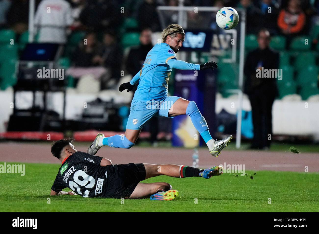Patricio Rodriguez of Bolivia's Bolivar, above, jumps over Ian Garguez ...