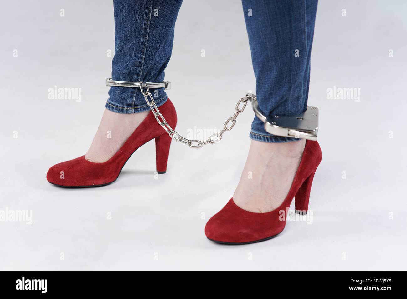 Feet in leg irons red sideways Stock Photo - Alamy