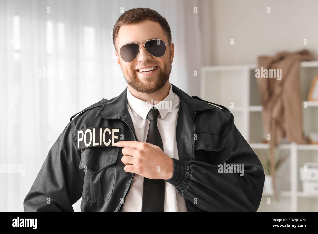 Handsome police officer smiling hi-res stock photography and images - Alamy