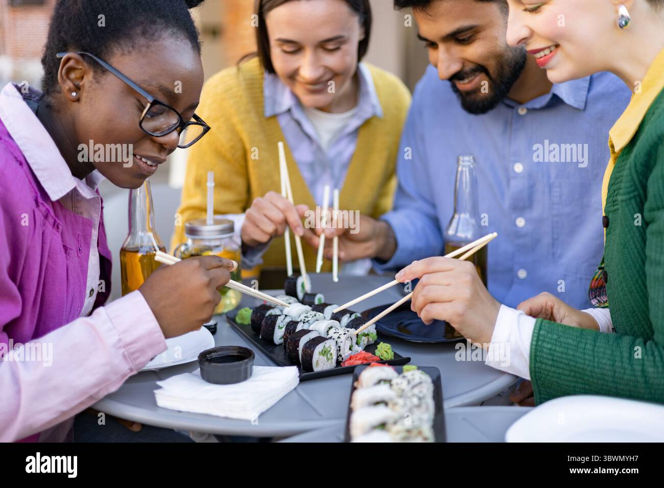 Friends Enjoying Sushi Together Stock Photo - Alamy