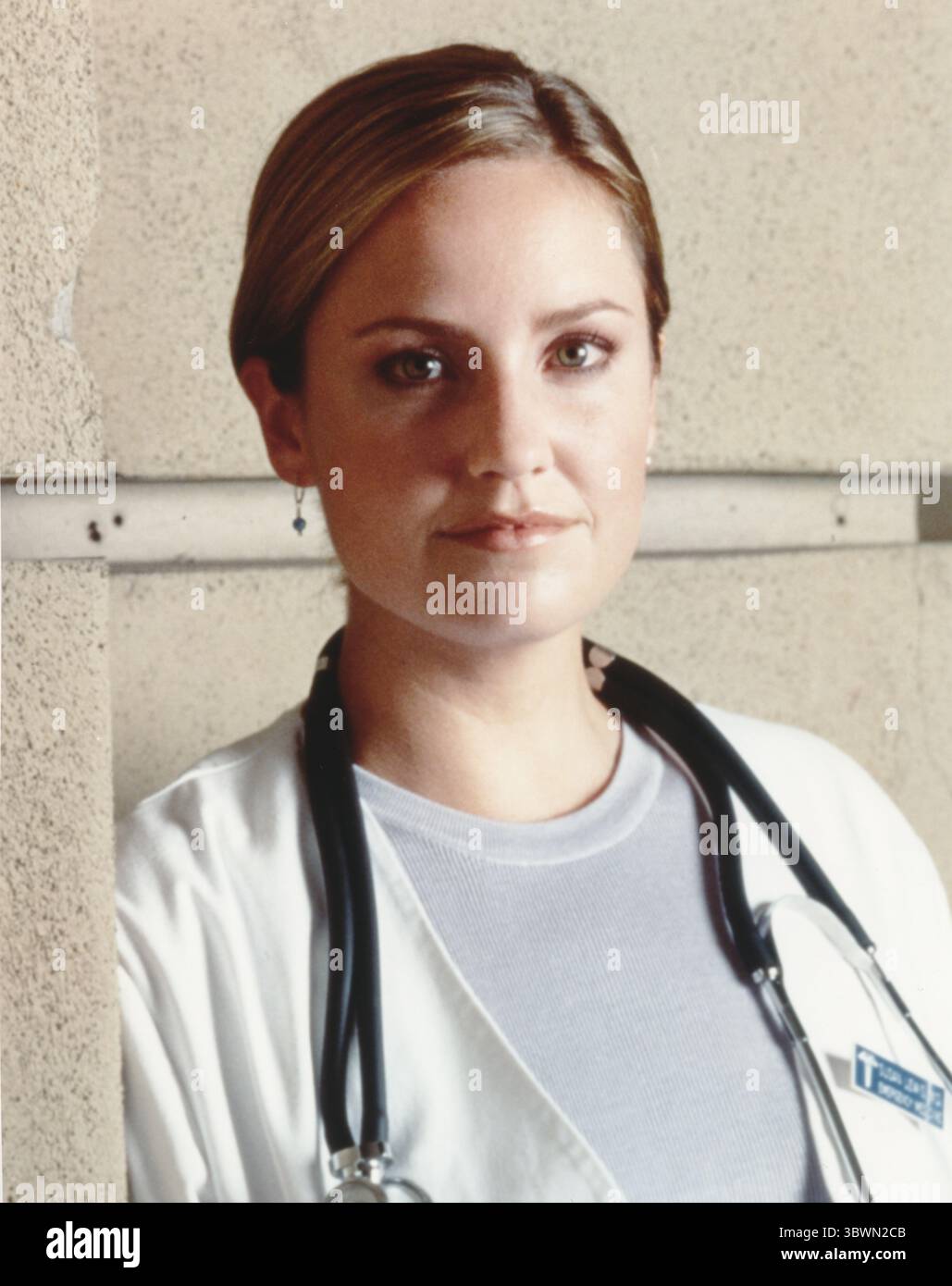 Sherry Stringfield Posed in White Long Sleeve Coat and Grey Round Neck ...