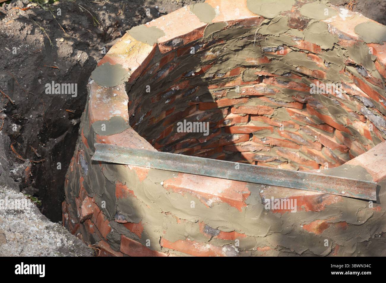 Installing brick septic tank. Sewer brick tank hole installation on ...