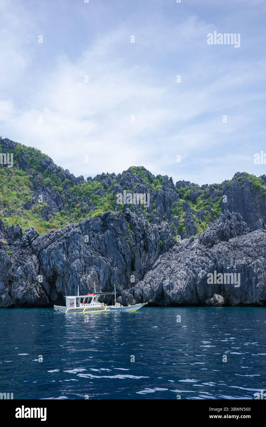 A Filipino boat is cruising along the ocean, bringing travelers from El ...