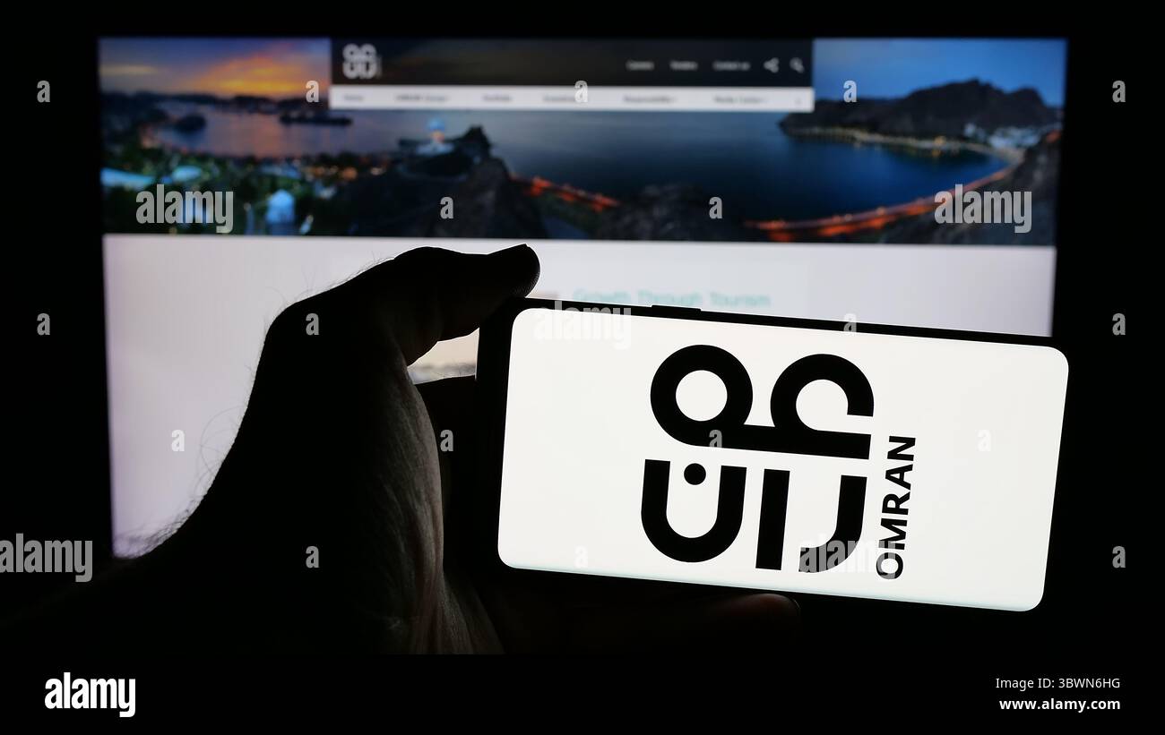 In this photo illustration, a mobile phone with the logo of Oman ...